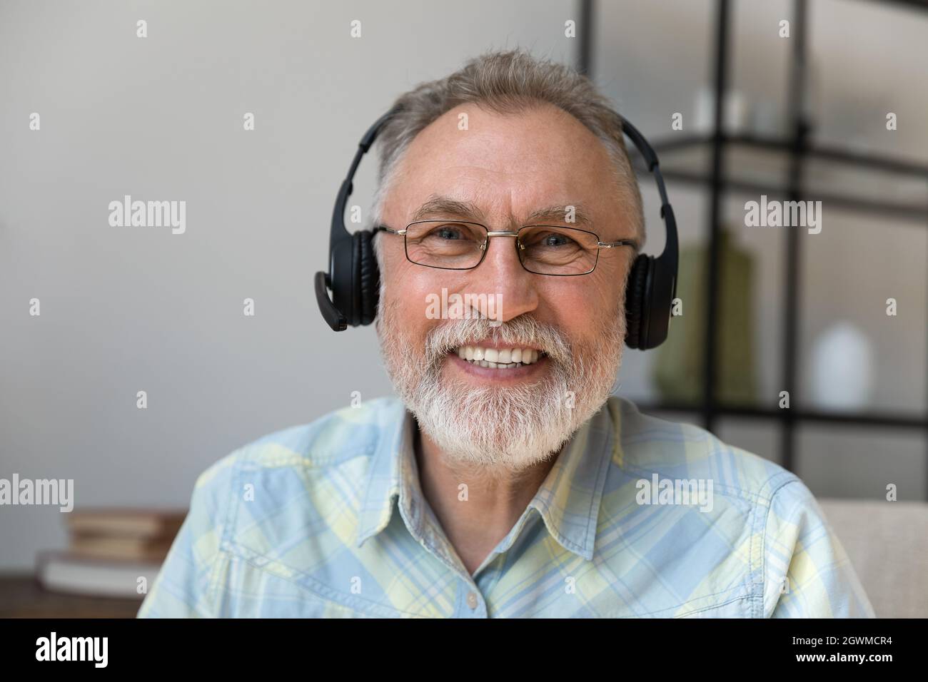 Smiling man headphones looking camera hi-res stock photography and images - Alamy