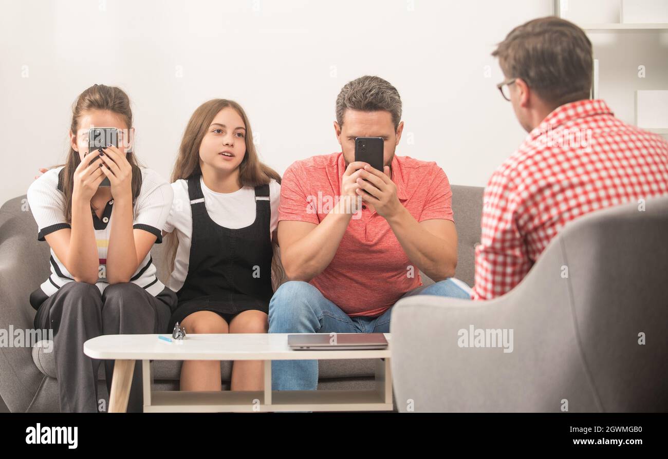parents with kid talk to social worker. phone addicted mom dad and ...
