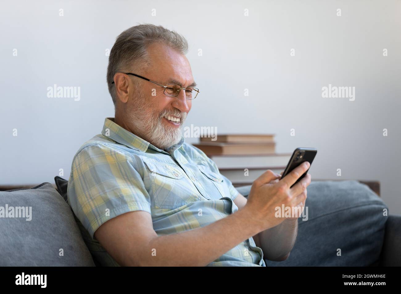 Joyful middle aged old man using cellphone Stock Photo - Alamy