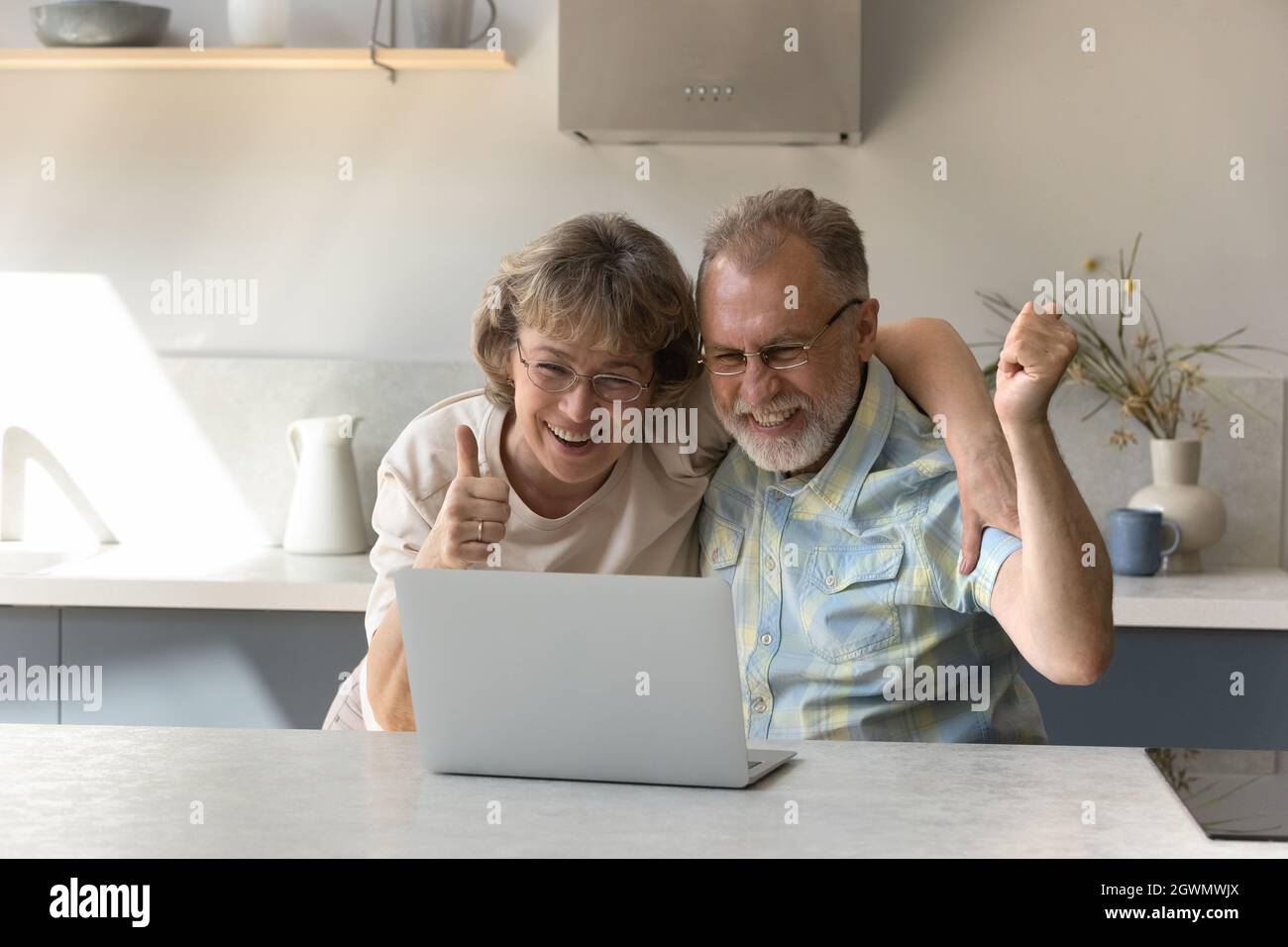 Happy middle aged couple celebrating internet success Stock Photo - Alamy
