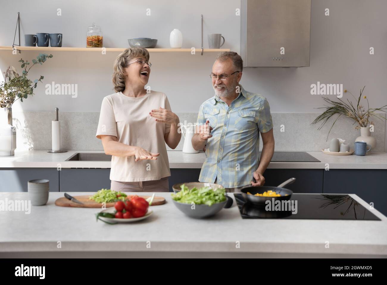 Carefree old family couple dancing, preparing food in kitchen Stock ...