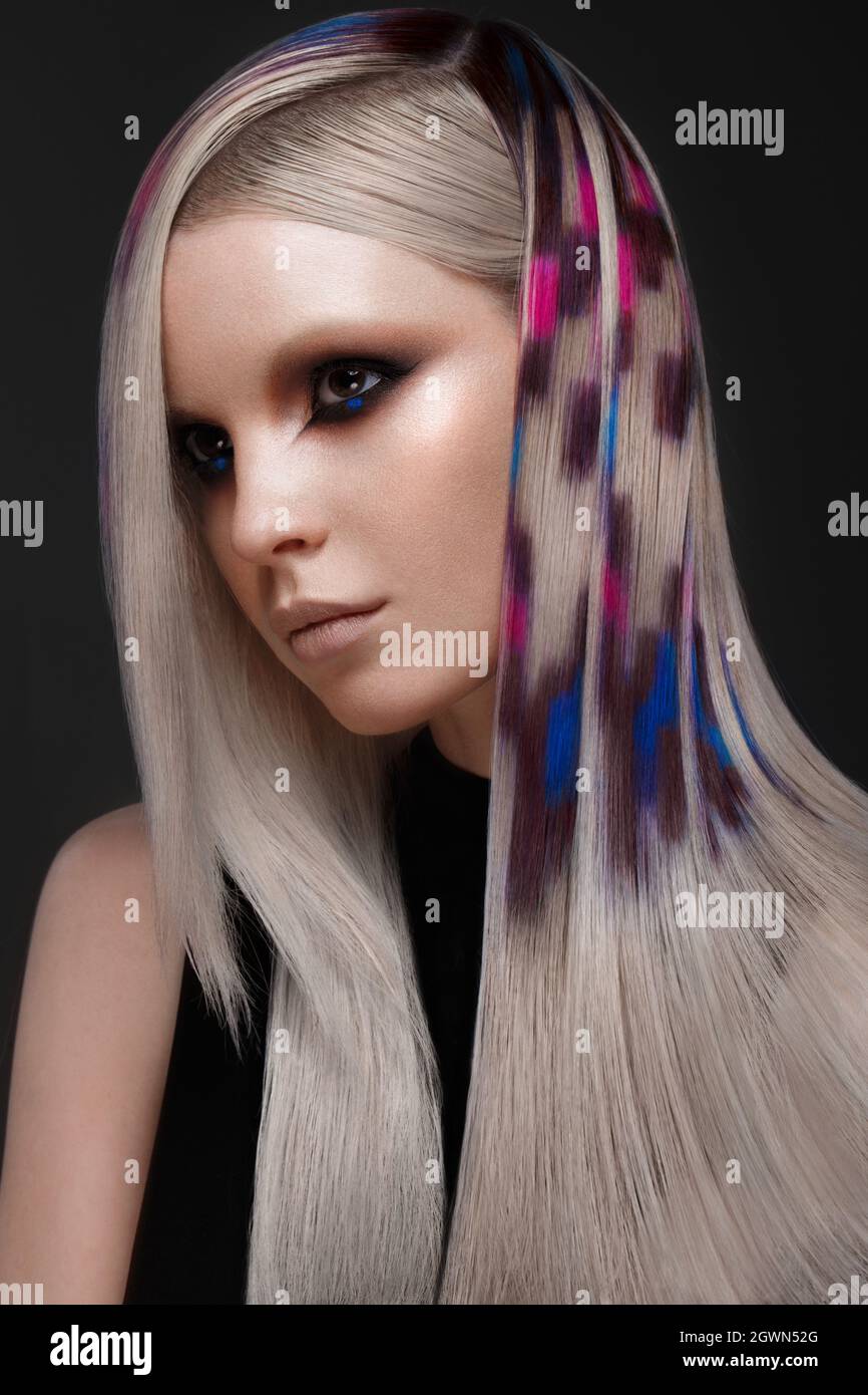 Beautiful girl with multi-colored hair and creative make up and ...