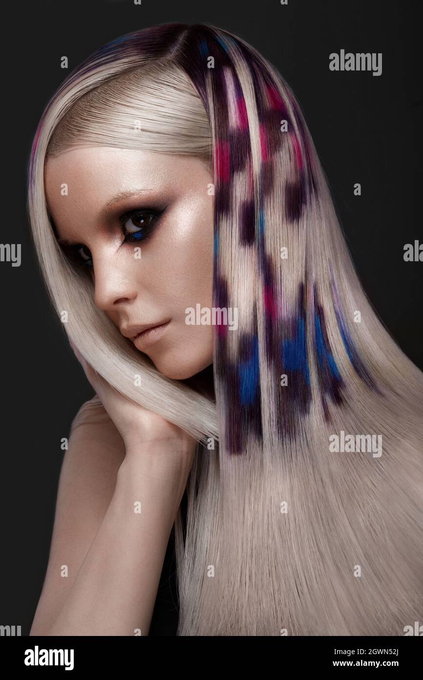 Beautiful girl with multi-colored hair and creative make up and ...