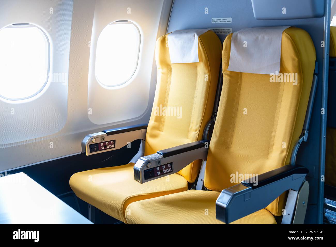 Empty Yellow Color Airplane Seat With Airplane Window Stock Photo - Alamy