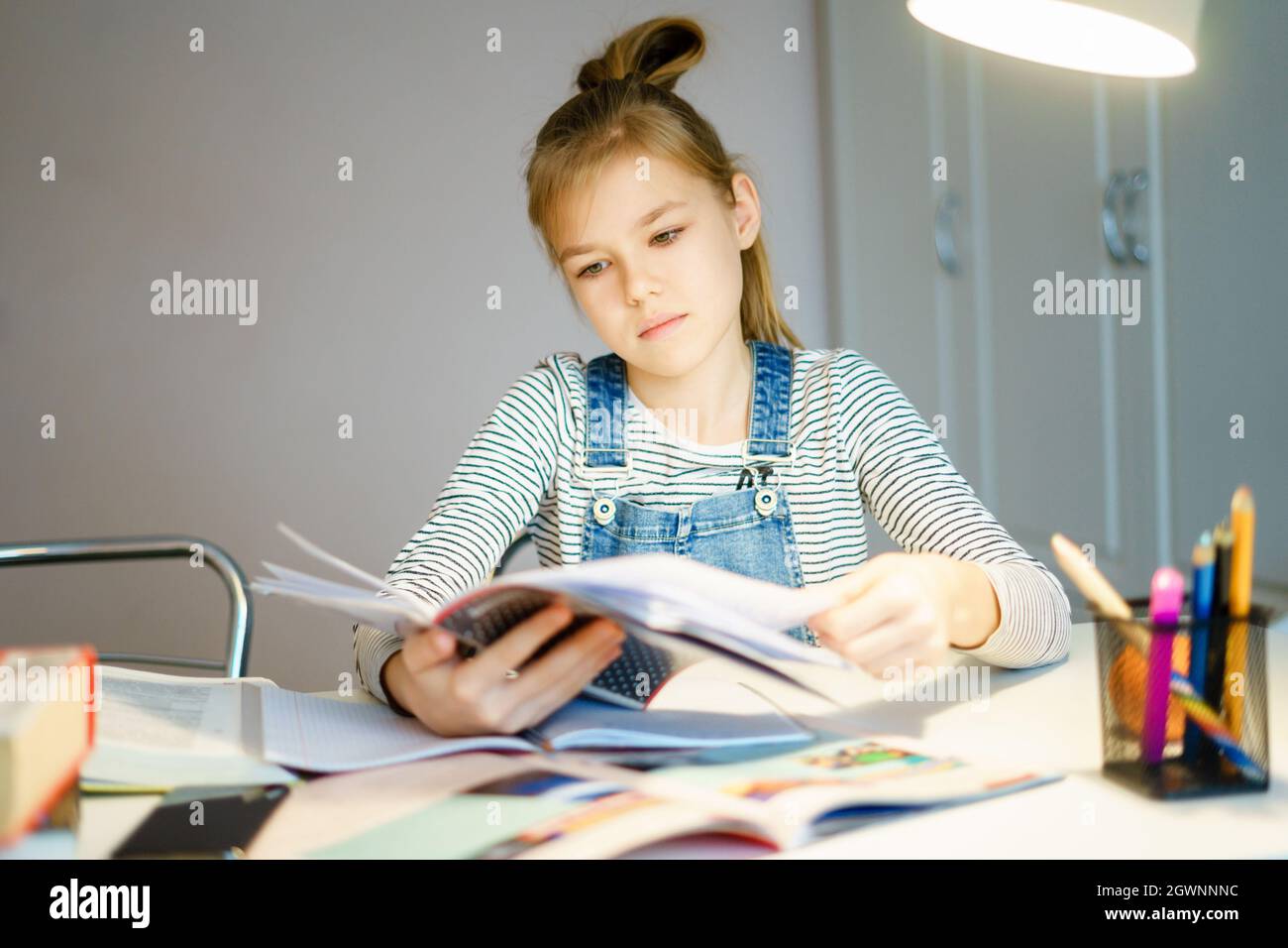 Portrait Of A Girl Sitting On Table Stock Photo - Alamy