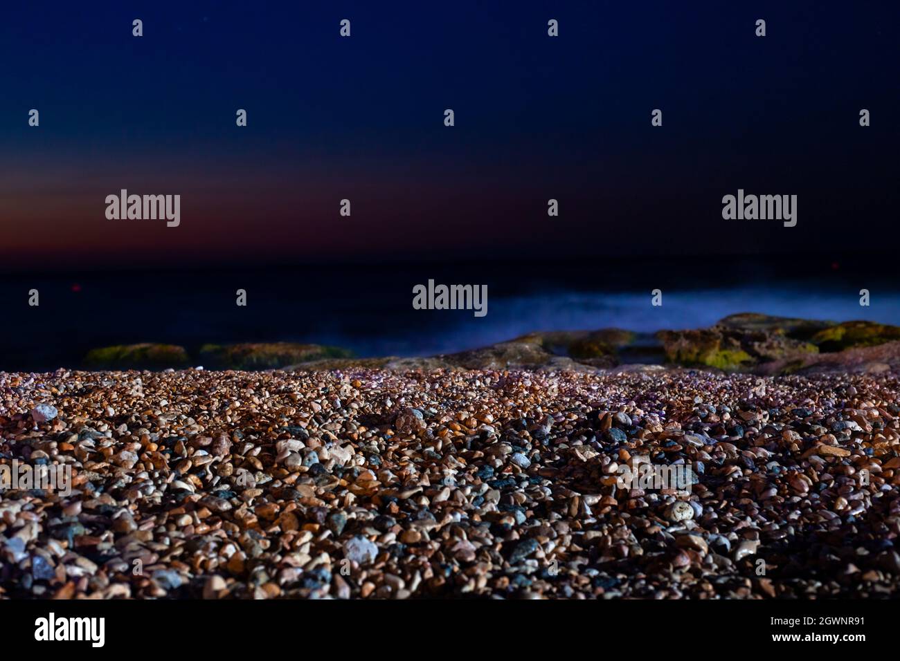 pebbles in the moonlight late at night by the sea Stock Photo - Alamy