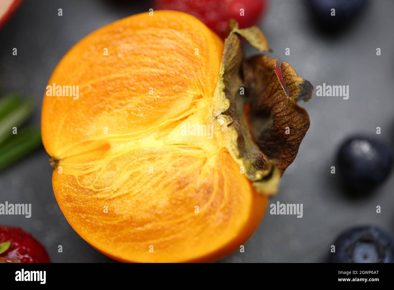 Persimmon fruit cut in half hi-res stock photography and images - Alamy