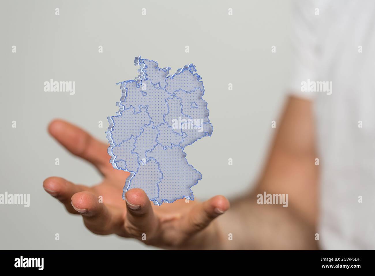 A 3D rendering of a digital Germany map in hand with a blurry ...