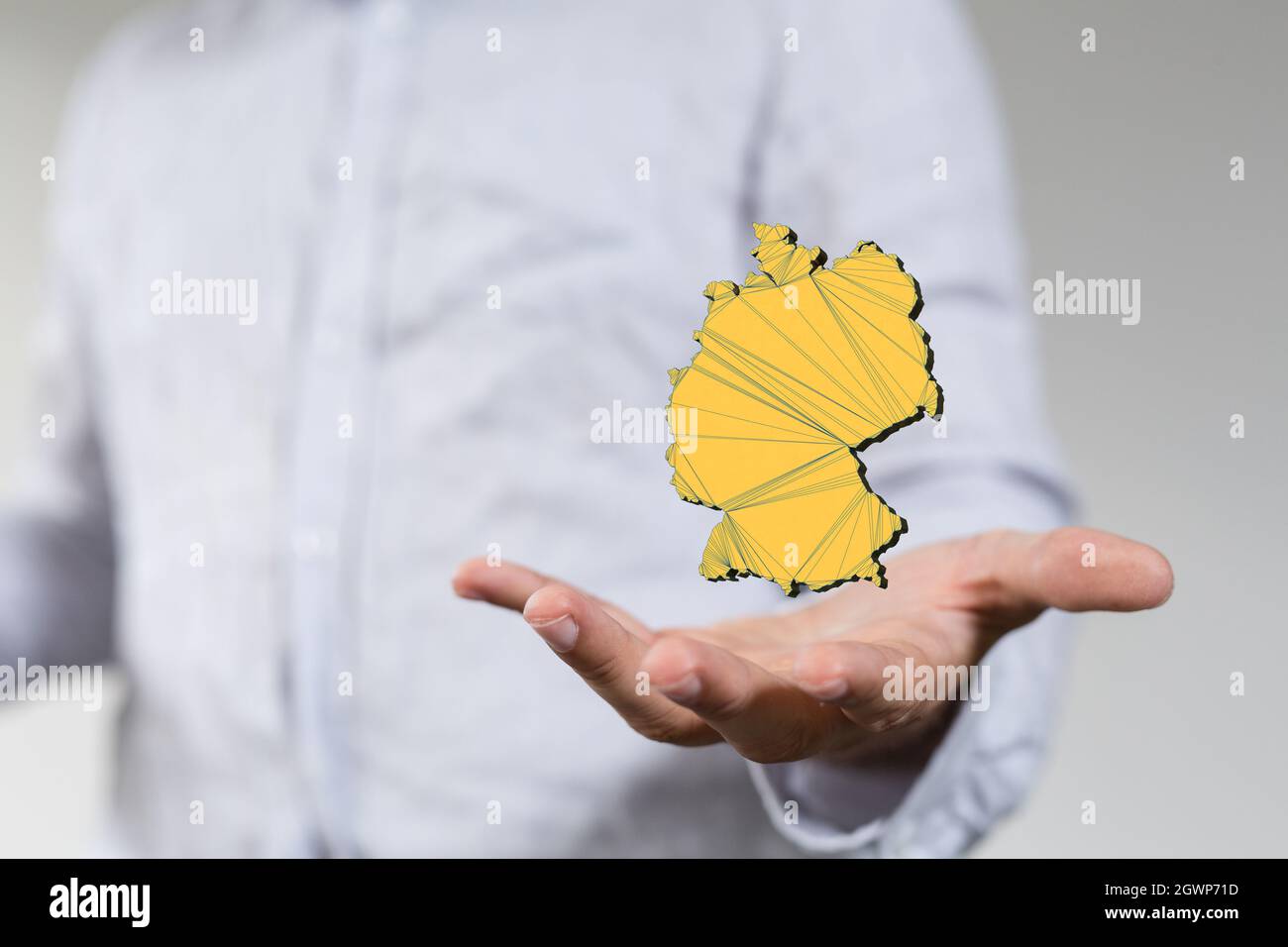 A 3D rendering of a digital Germany map in hand with a blurry ...
