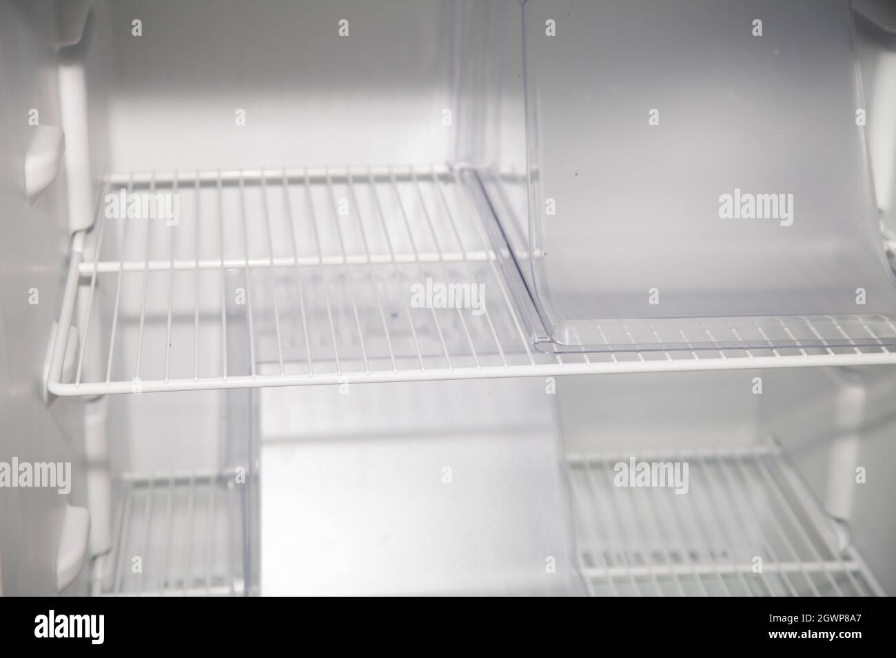 Empty shelves inside a clean, empty, white refrigerator Stock Photo - Alamy