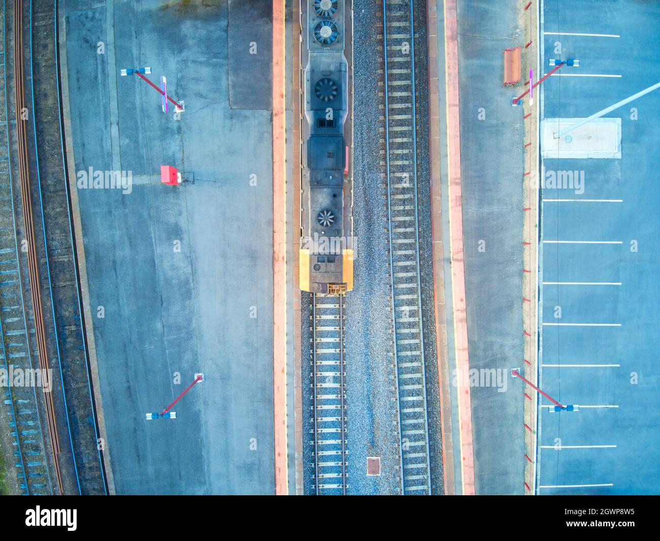 Aerial view train station platform, train tracks and train engine ...