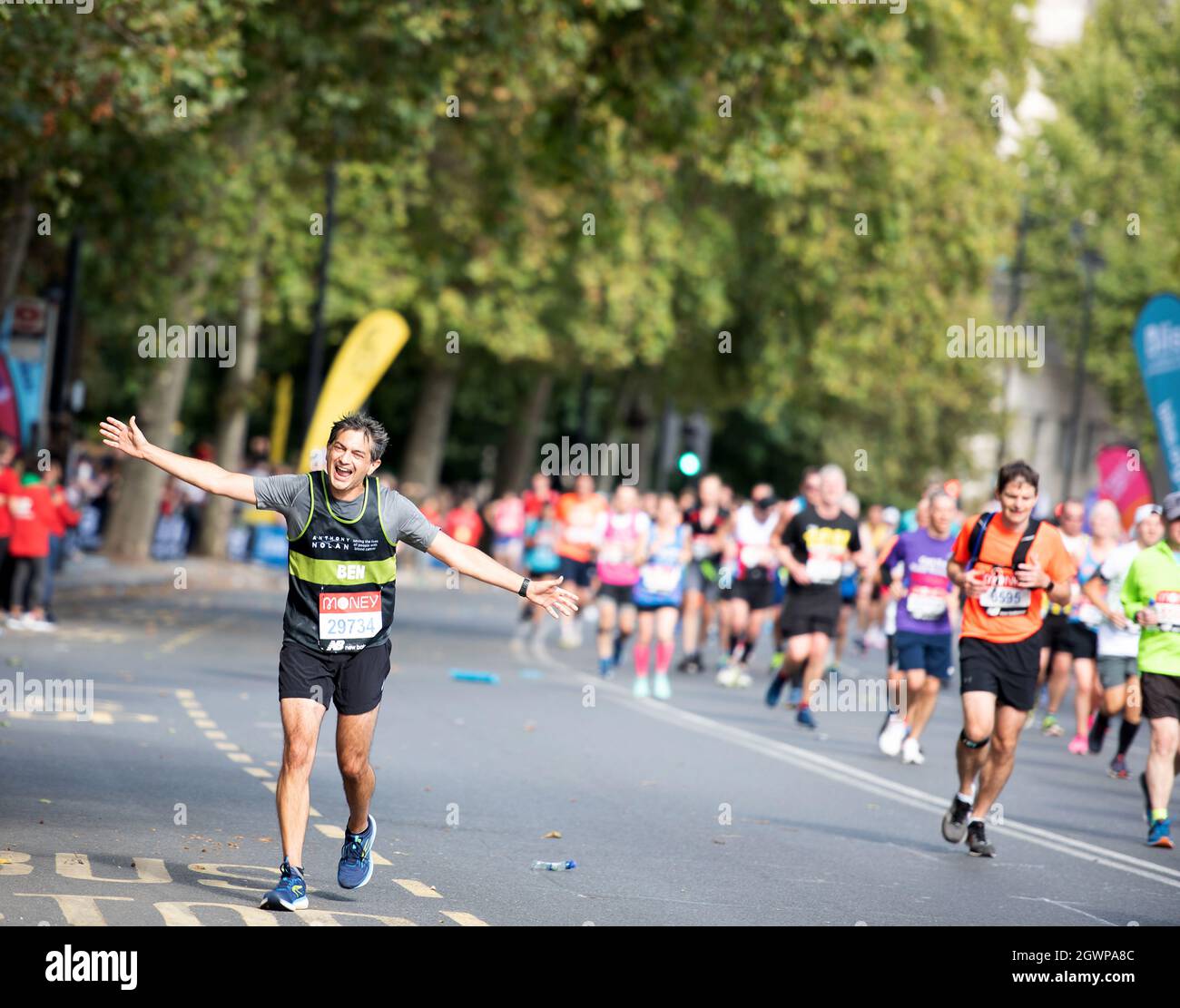 A runner cheers with the spectators while participating in the Virgin ...
