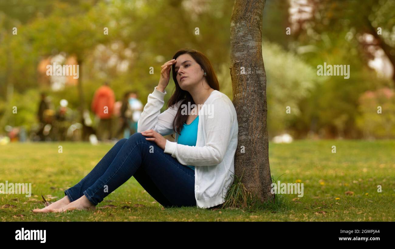 Female sitting under a tree hi-res stock photography and images - Alamy