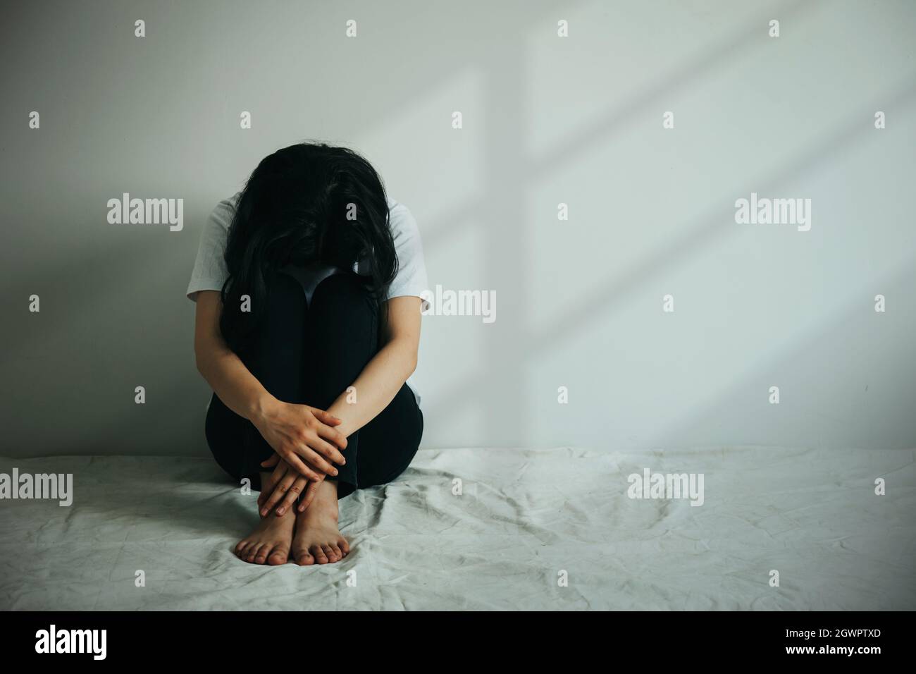 Sad woman hug her knee and cry hi-res stock photography and images - Alamy