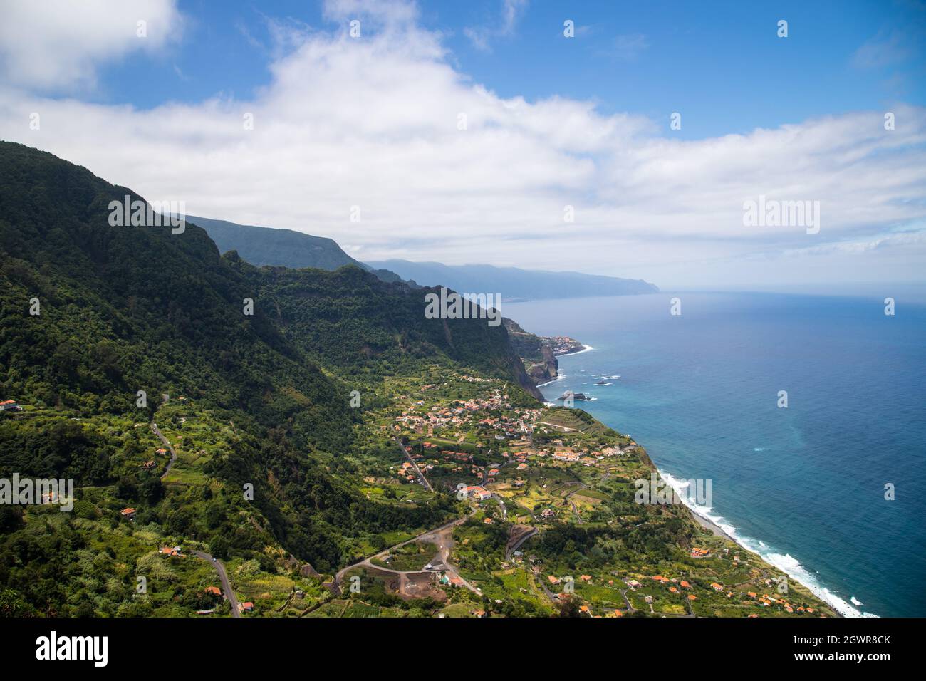 Green Mountains and a Small Village by the sea seen from "Cabo Girão ...