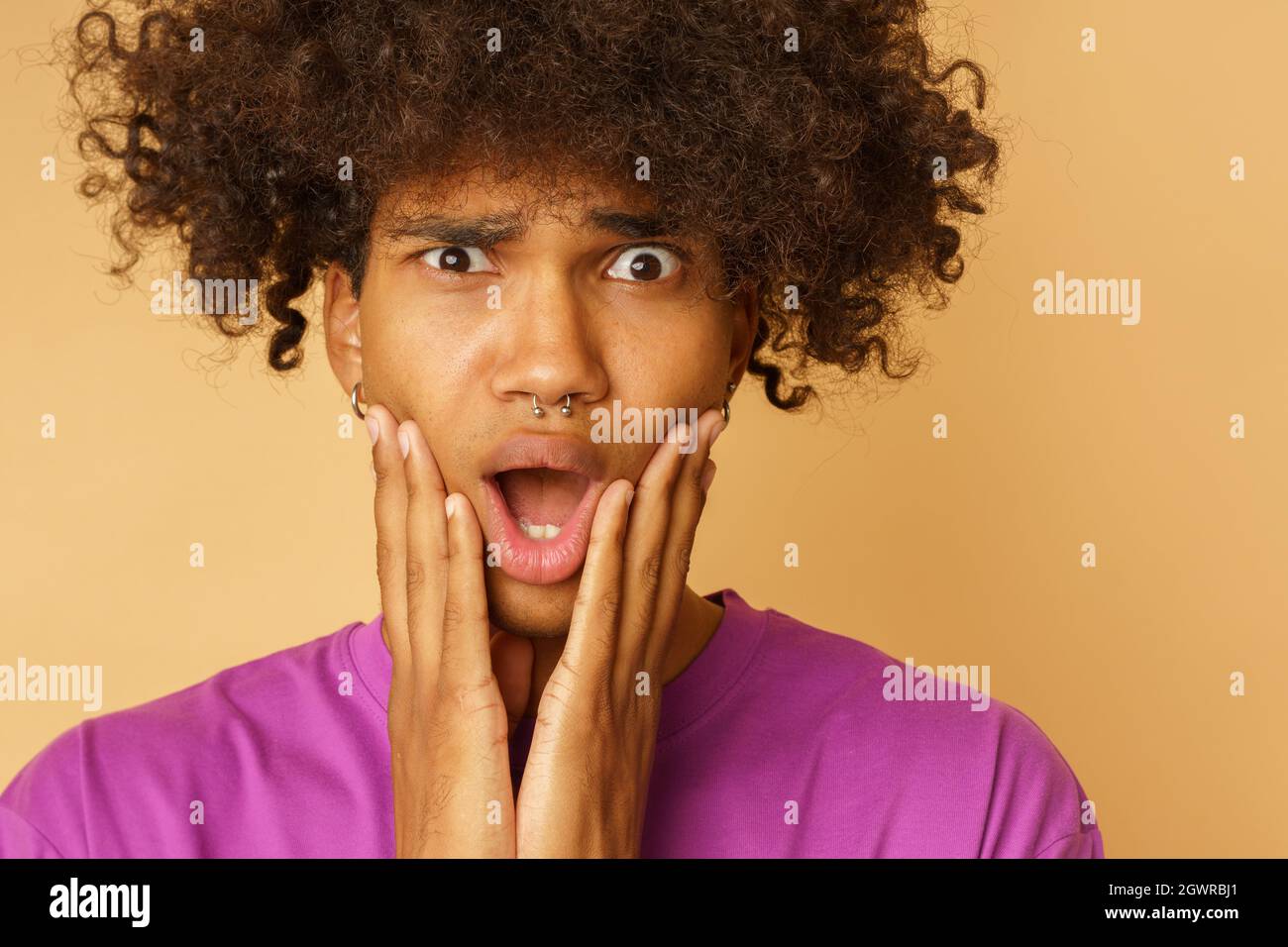 Afro man with curly hair is amazed about something Stock Photo - Alamy