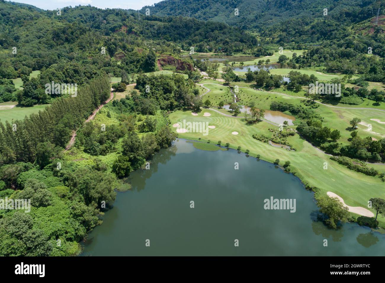 Aerial view drone shot of beautiful green golf field fairway and ...