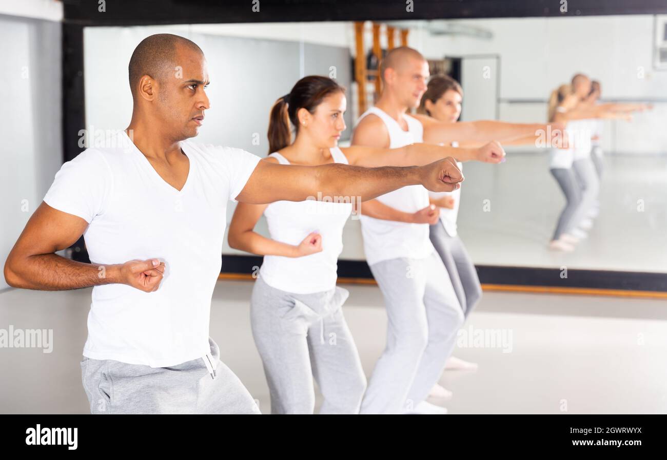 Men and women mastering self-defense techniques in training room Stock ...