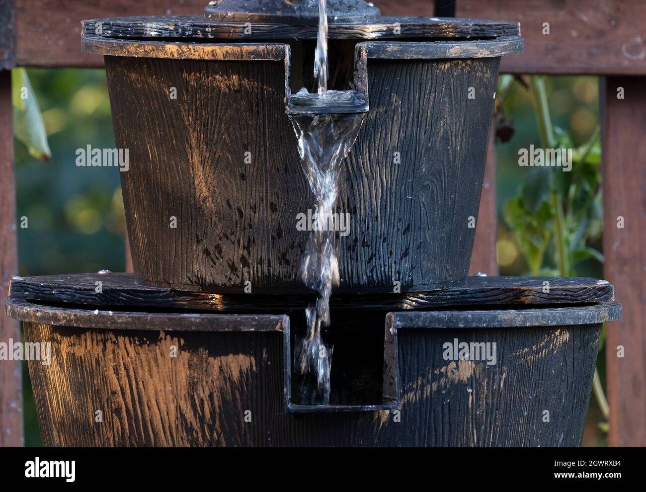 Water cascades from a wooden bucket Stock Photo - Alamy