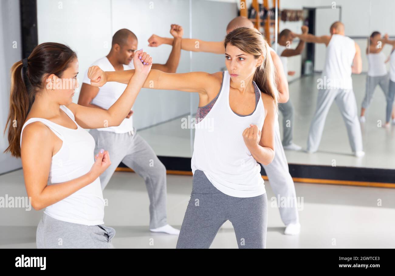 Two young women practicing basic self defense skills at gym Stock Photo ...