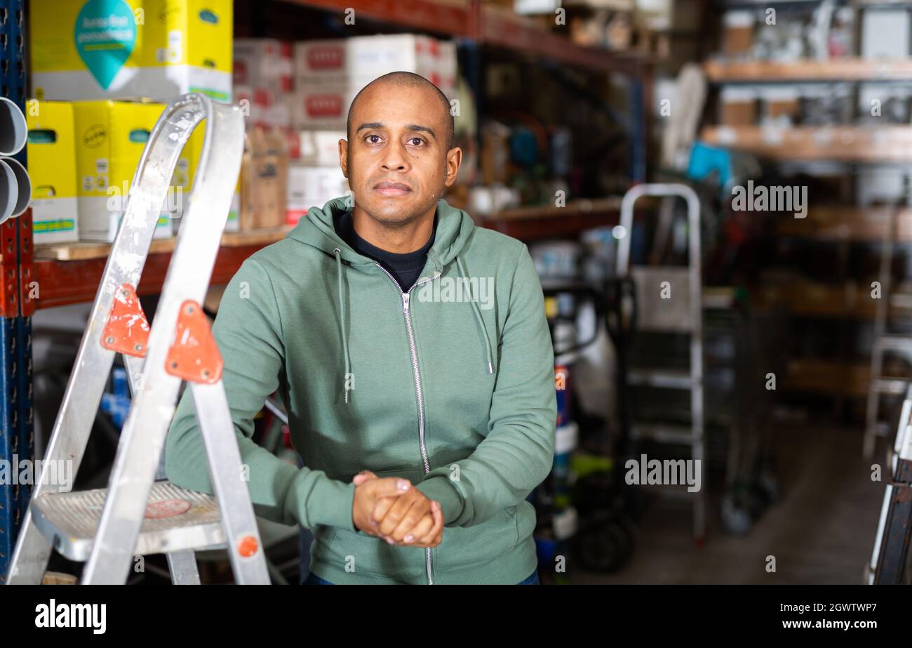 Confident Hispanic man owner of building materials store Stock Photo ...
