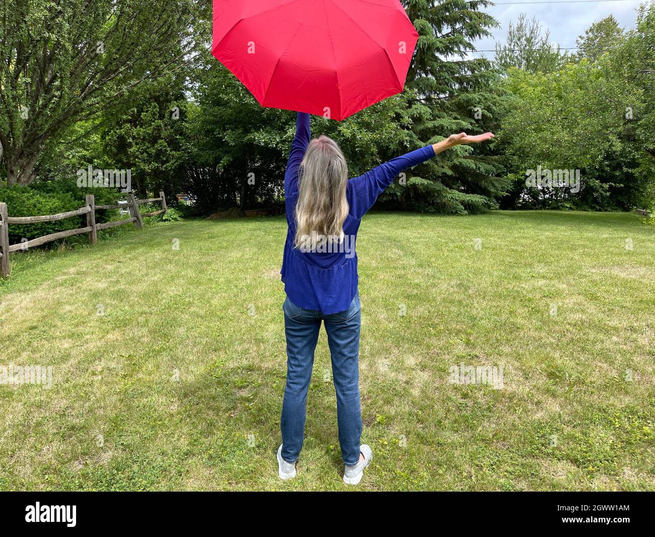 Holding an umbrella over her head hi-res stock photography and images ...