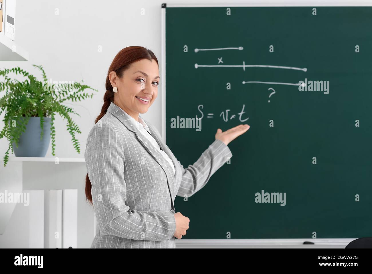 Teacher conducting lesson in classroom Stock Photo - Alamy