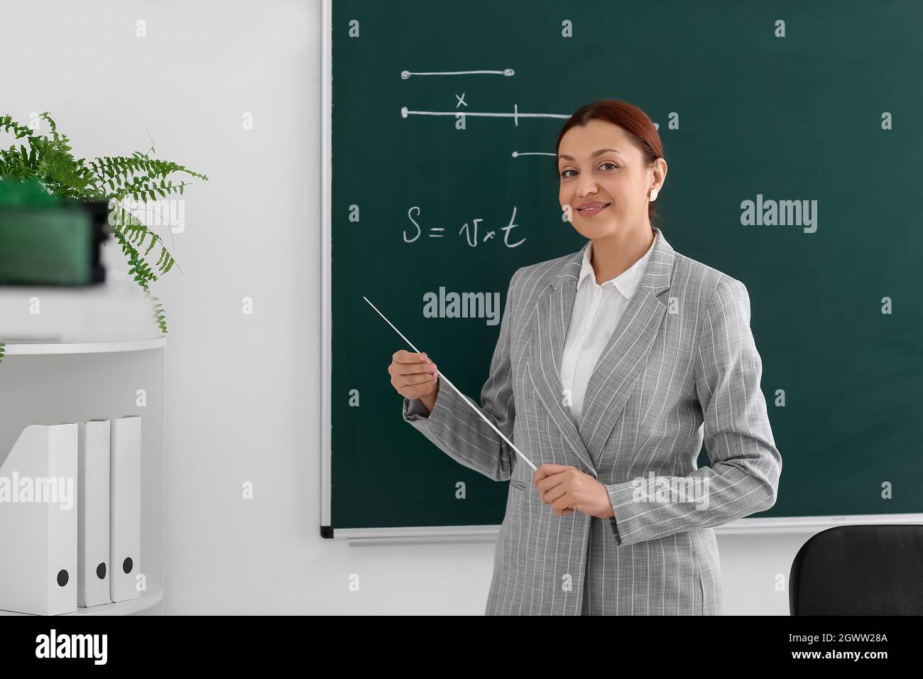 Teacher conducting lesson in classroom Stock Photo - Alamy