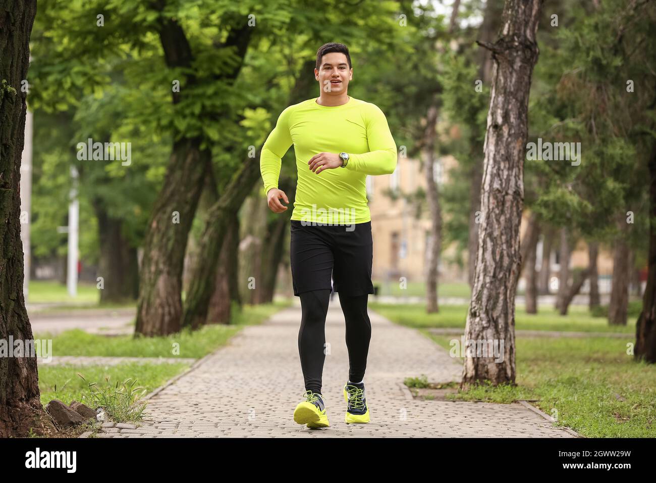 Muscular young man running in park Stock Photo - Alamy