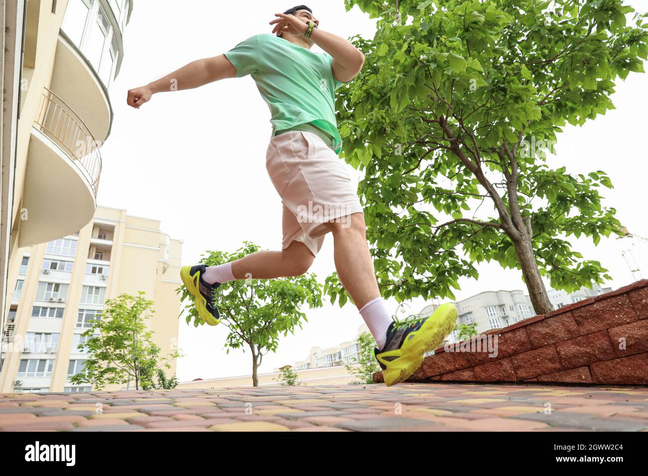 Muscular young man jumping outdoors Stock Photo - Alamy