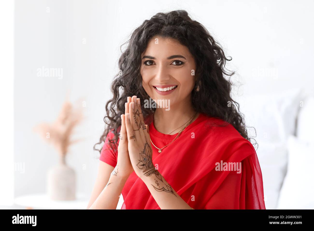 Beautiful Indian woman with henna tattoo at home Stock Photo - Alamy