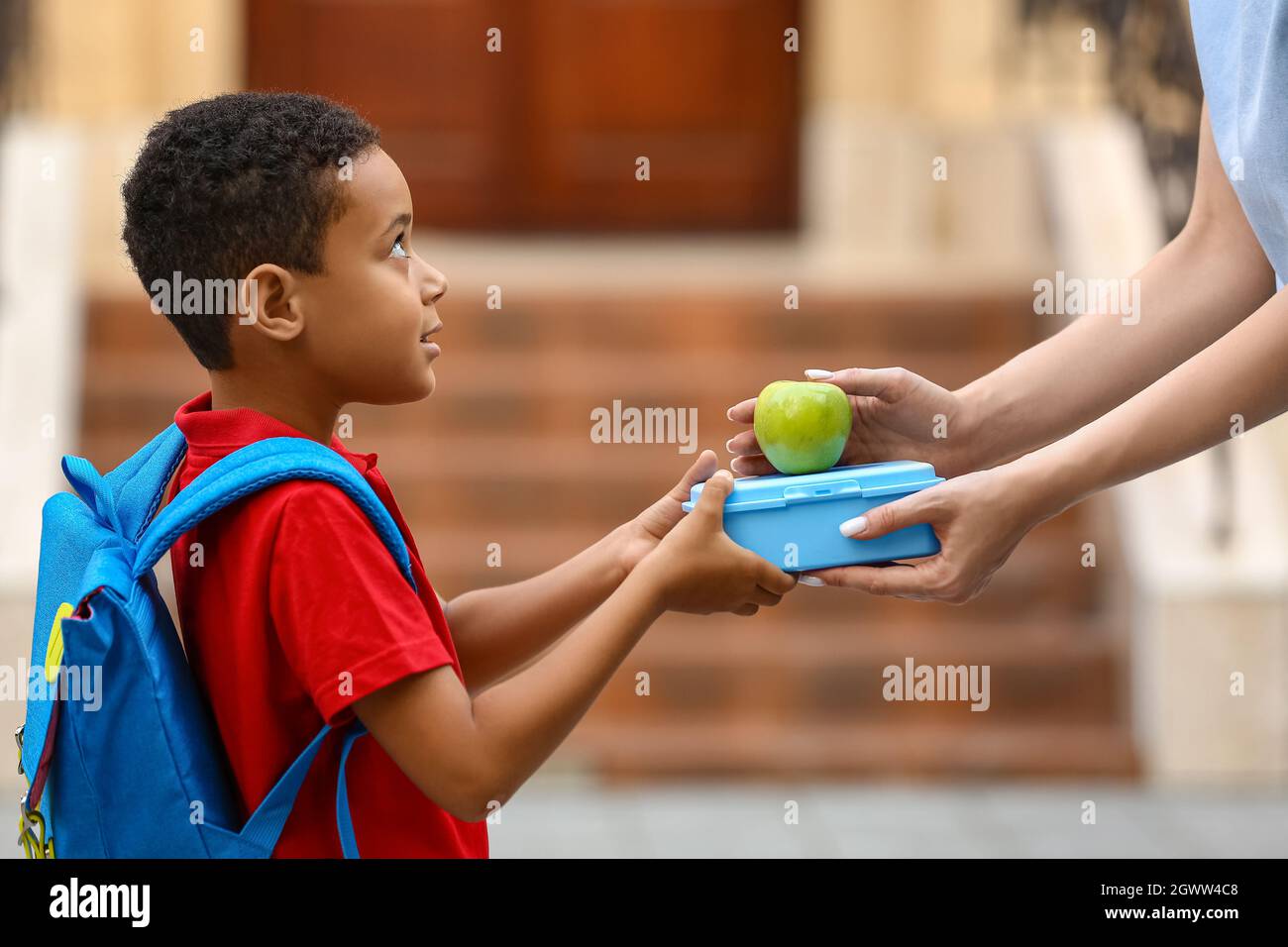 Mother giving lunch to her little son before school Stock Photo - Alamy