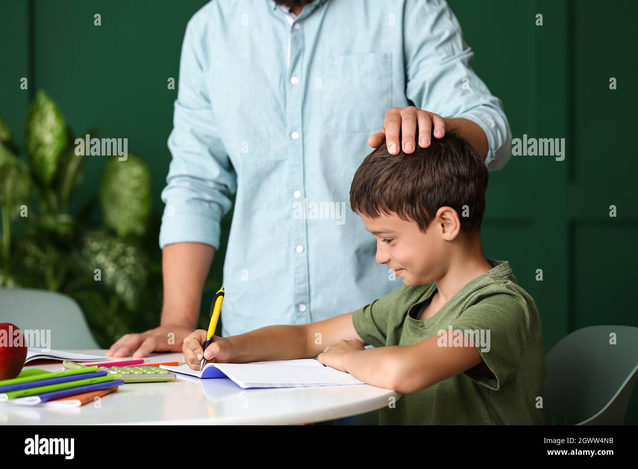 Little boy with his father doing lessons at home Stock Photo - Alamy