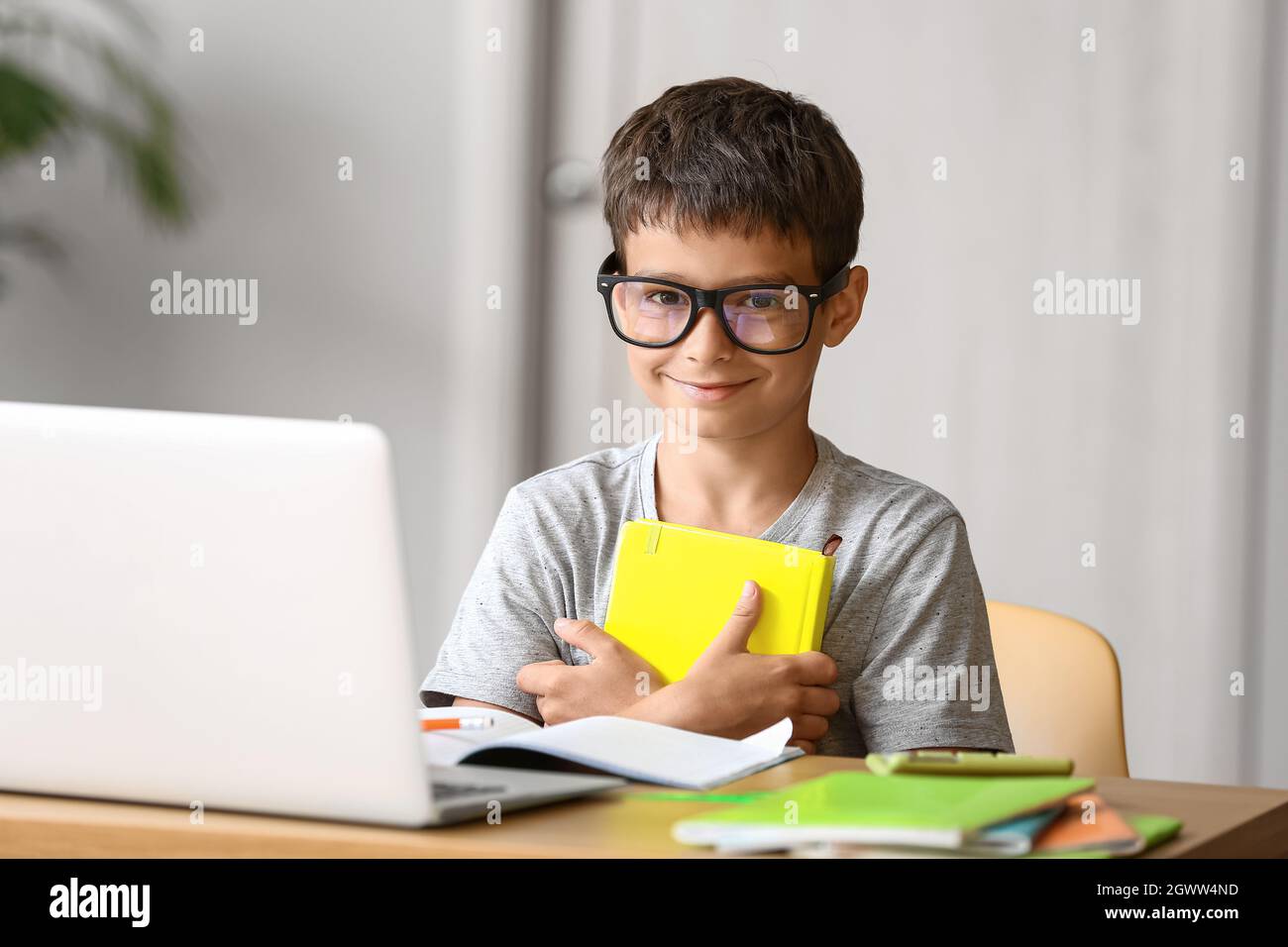 Little boy doing lessons at home Stock Photo - Alamy