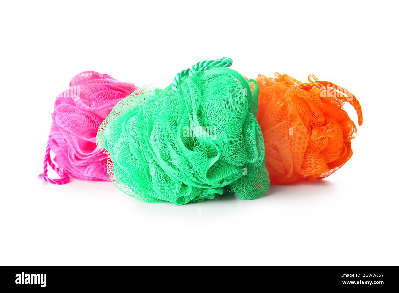 Different bath sponges on white background Stock Photo - Alamy