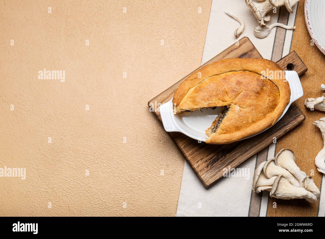 Baking dish with tasty mushroom pot pie on beige background Stock Photo ...