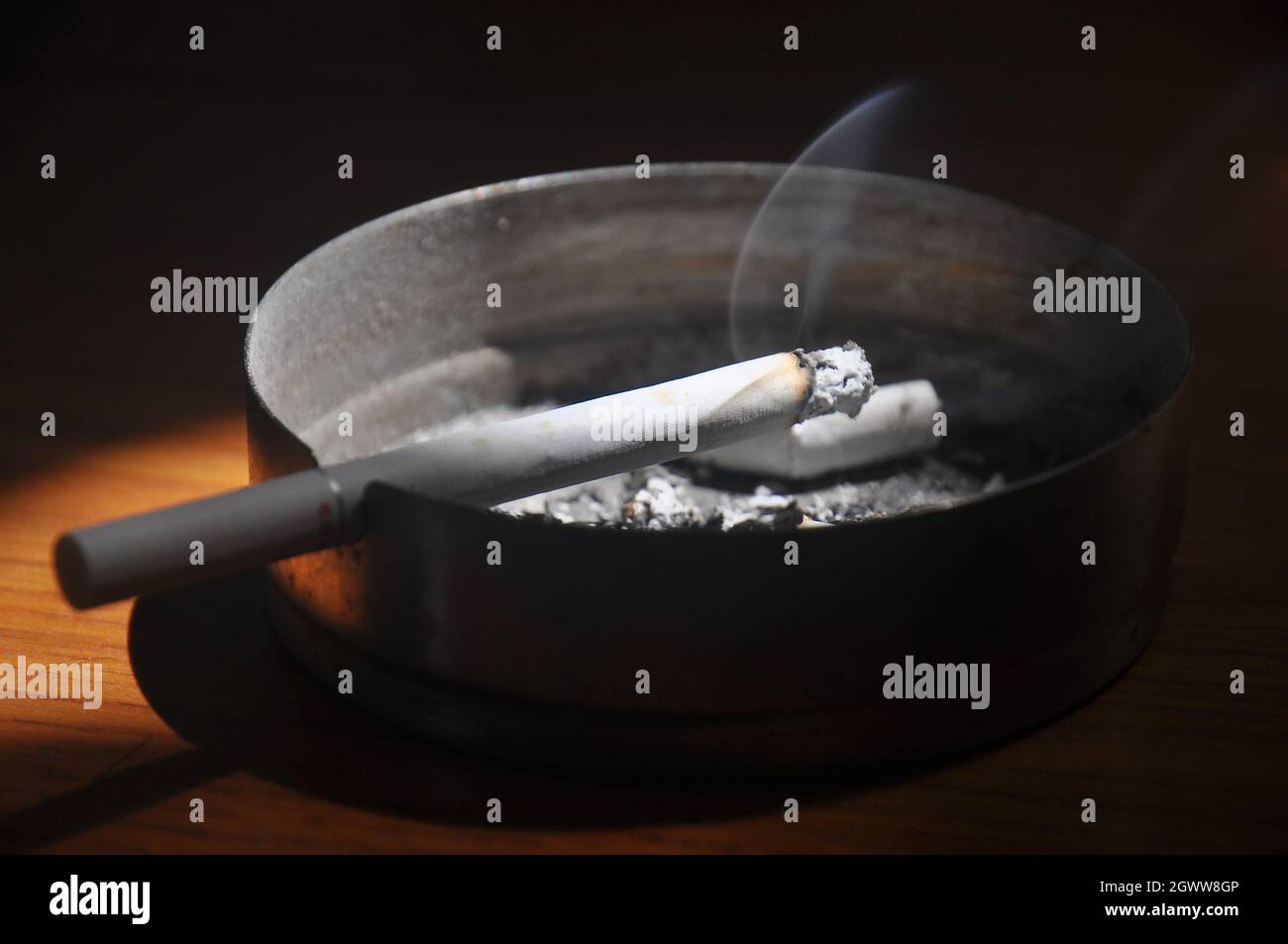 Ashtray burning cigarette on black hi-res stock photography and images ...