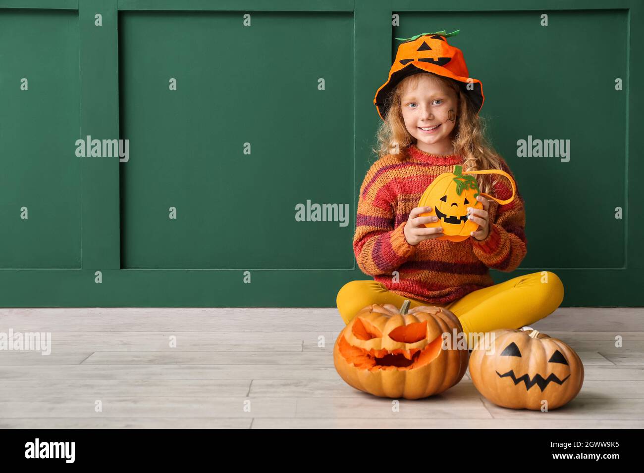 Cute little girl in Halloween costume on color background Stock Photo ...