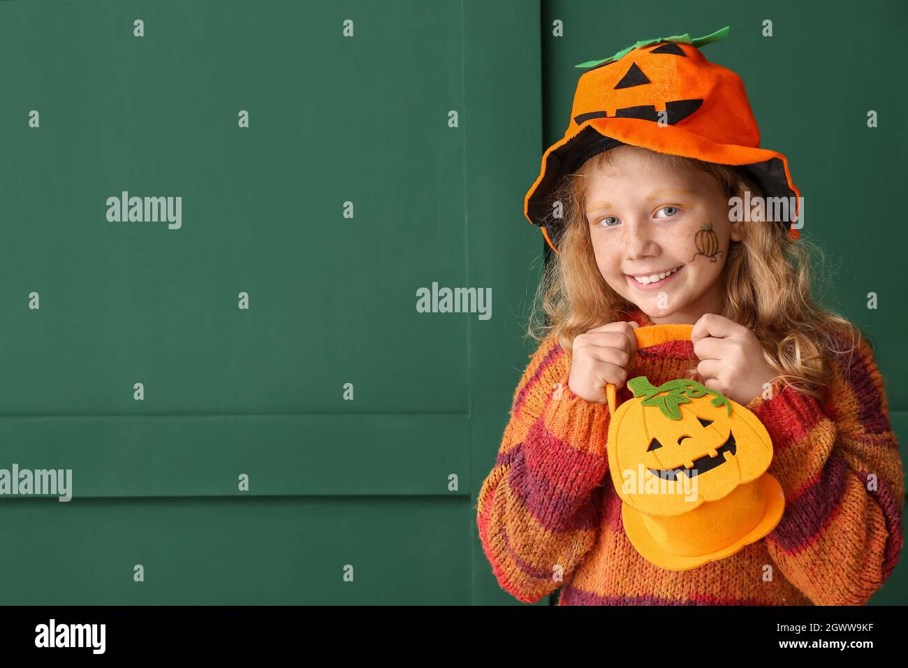 Cute little girl in Halloween costume on color background Stock Photo ...