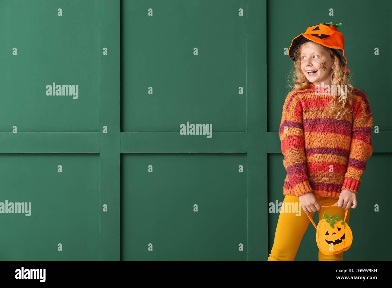 Cute little girl in Halloween costume on color background Stock Photo ...