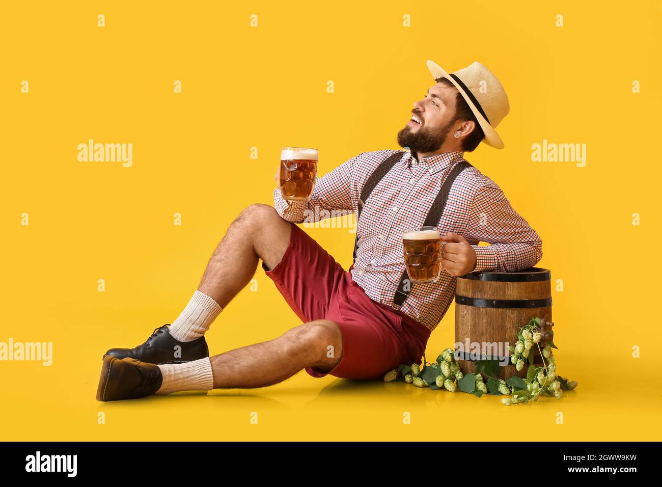 Handsome man in traditional German clothes and with beer on color ...
