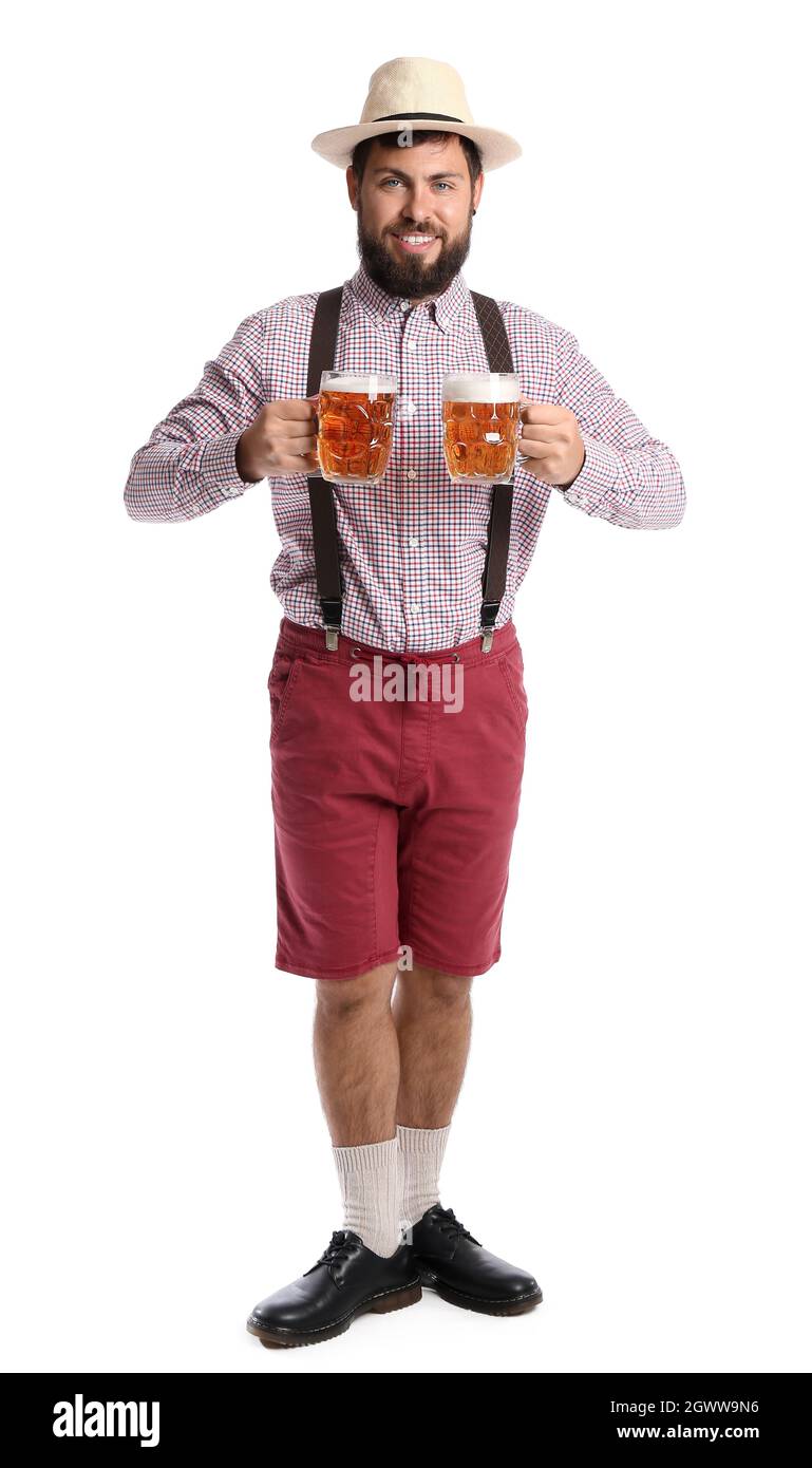Handsome man in traditional German clothes and with beer on white ...