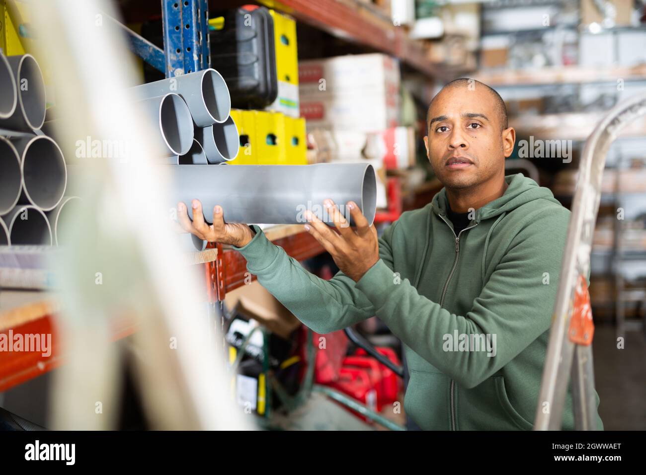 Craftsman selects plastic plumbing pipes in hardware store Stock Photo ...