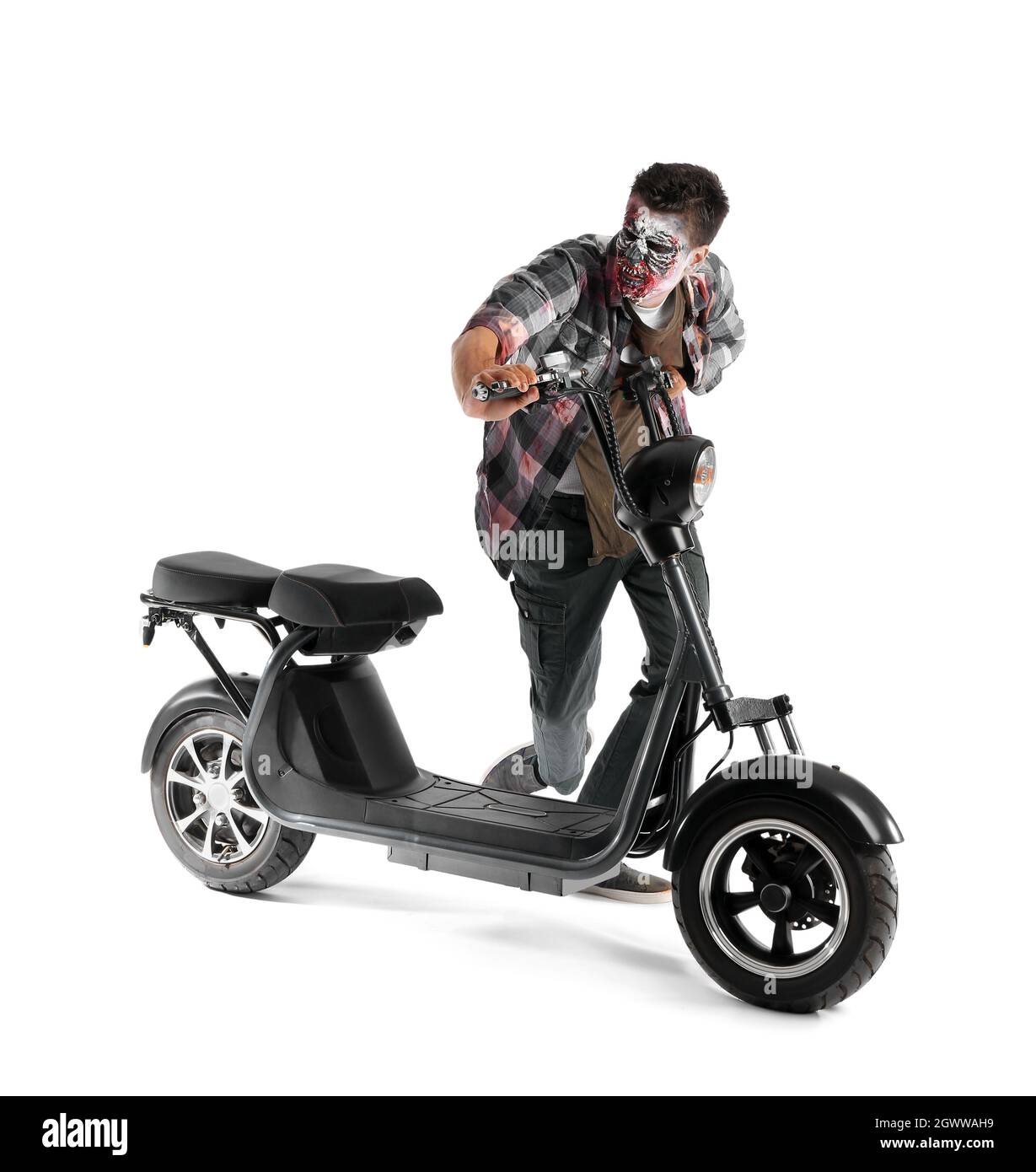 Man dressed for Halloween as zombie with motorcycle on white background ...