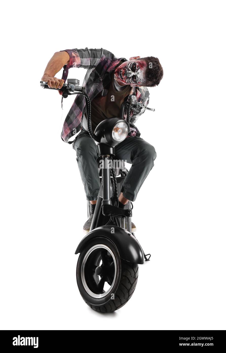 Man dressed for Halloween as zombie with motorcycle on white background ...
