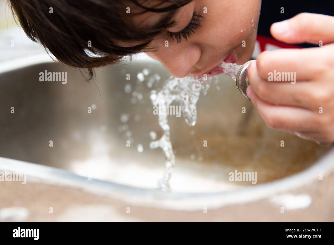 Boy drink water tap hi-res stock photography and images - Alamy