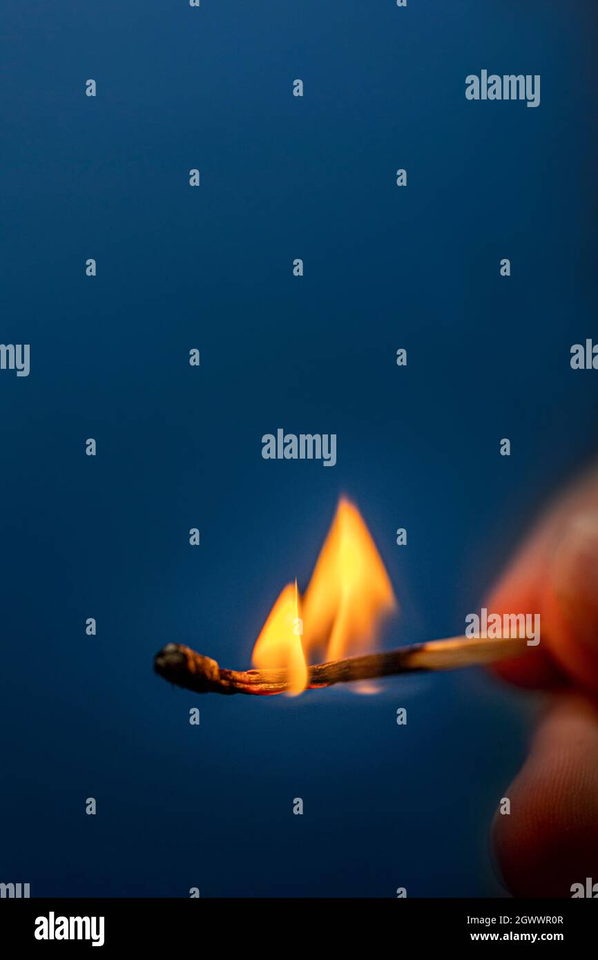 Human Hand Holding A Lighted Match With A Flame Stock Photo - Alamy