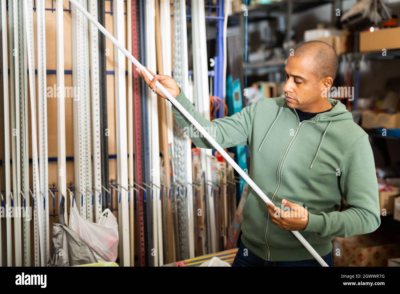 Latin american man choosing building materials in store Stock Photo - Alamy