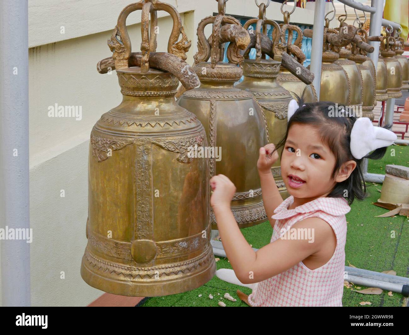 Girl ringing temple bell hi-res stock photography and images - Alamy