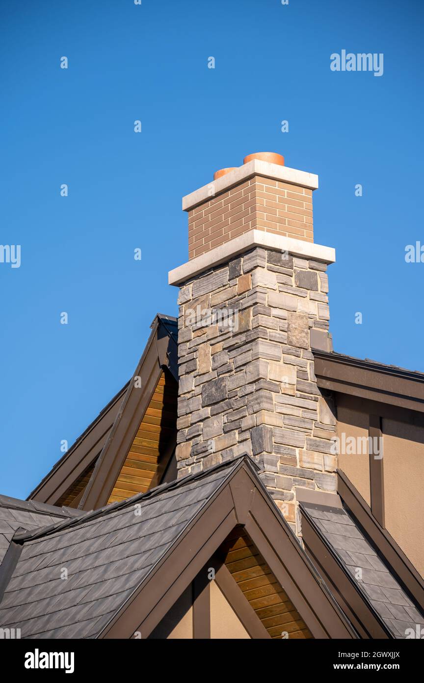Stone chimny on a modern luxury home in Calgary Stock Photo - Alamy